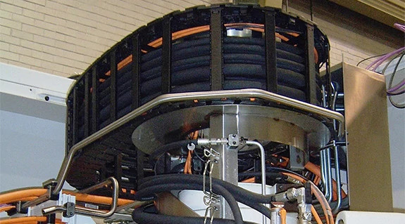 Cable routing in CNC grinding machine for oil and chips | igus® | igus ...